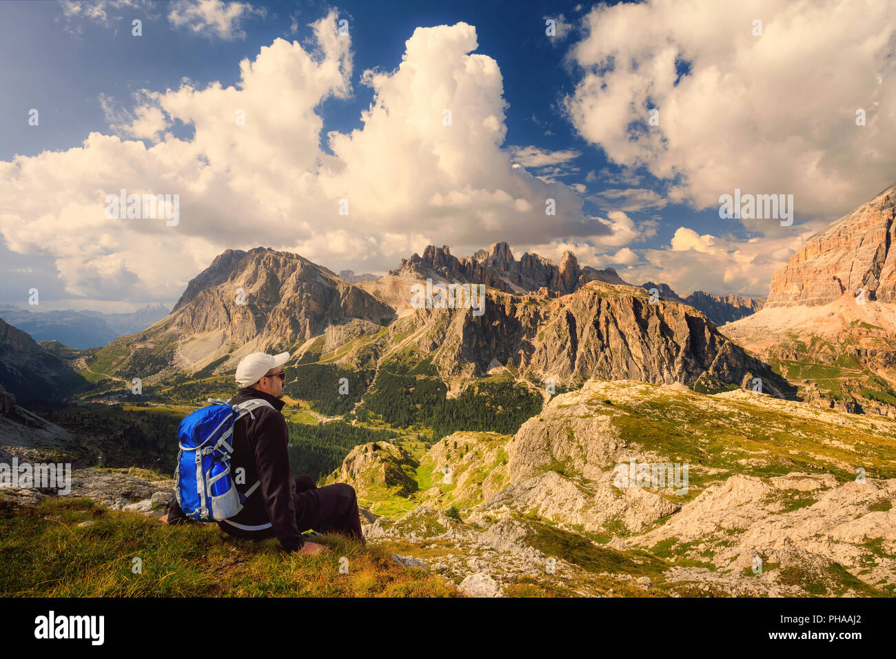 Nestled in the beautiful alpine scenery, a man admires the high ...