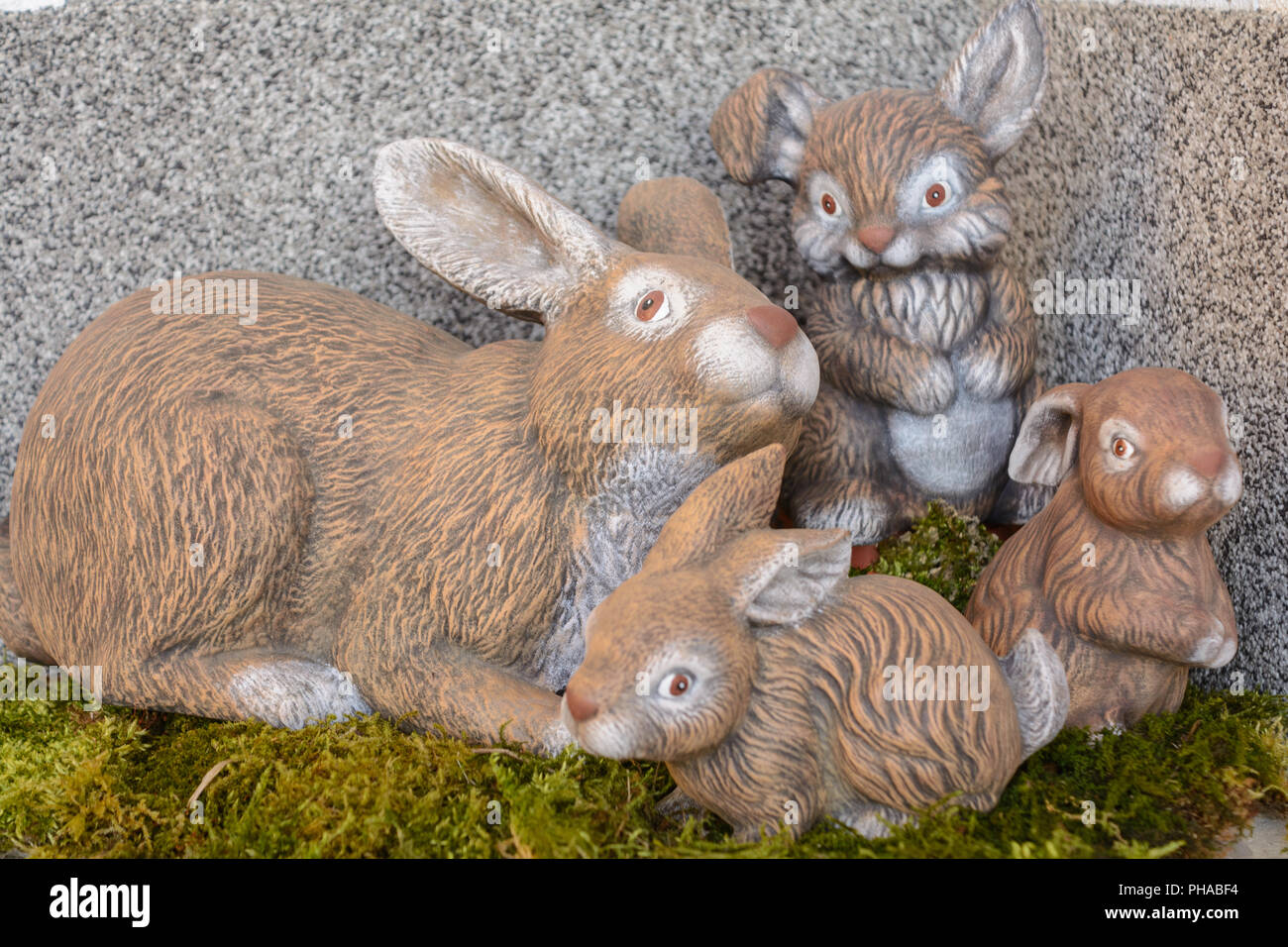 Decorative Easter bunny figures from ceramics on moss Stock Photo - Alamy