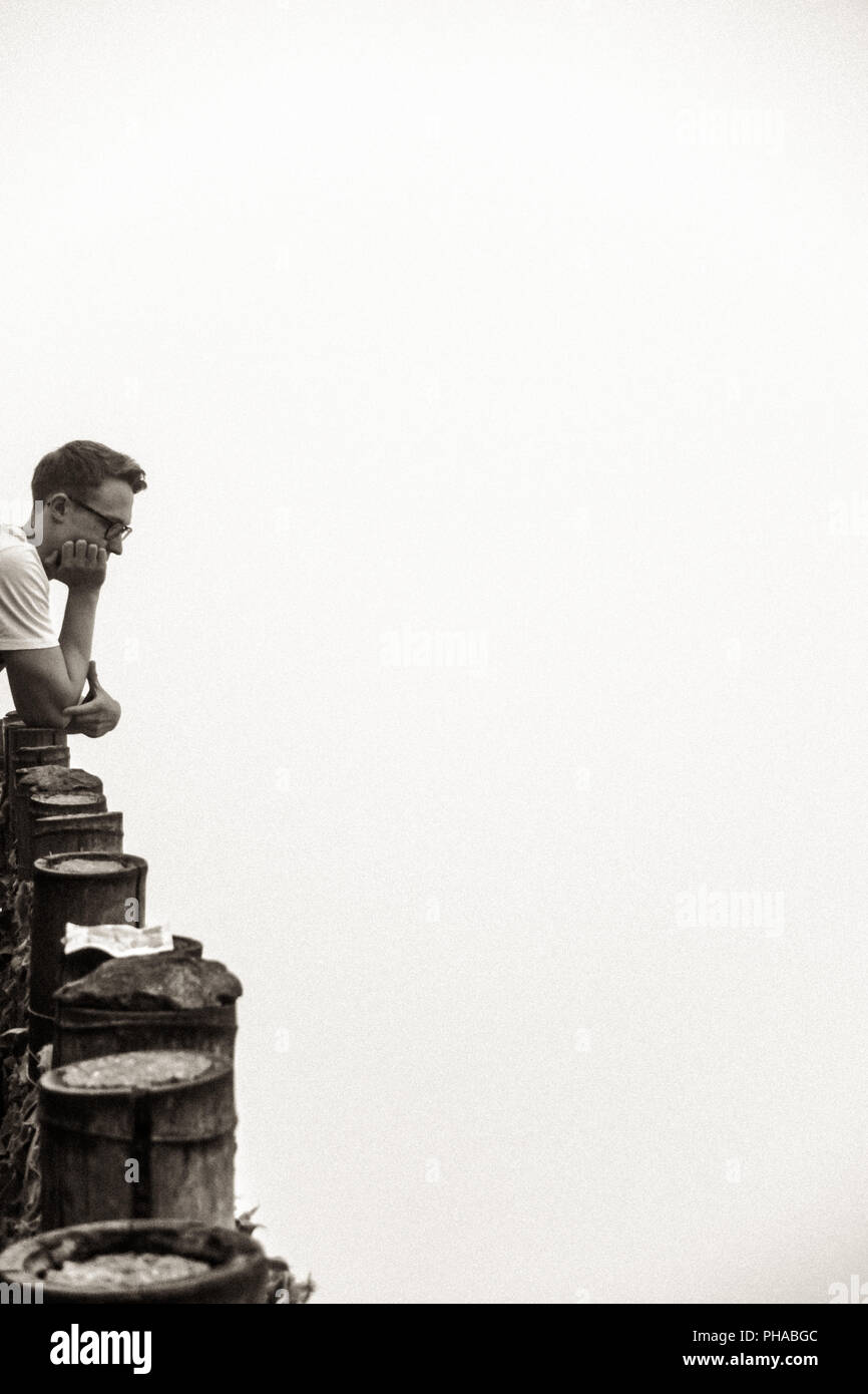 Person Thinking Alone on Cloudy Backdrop B/W Stock Photo - Alamy