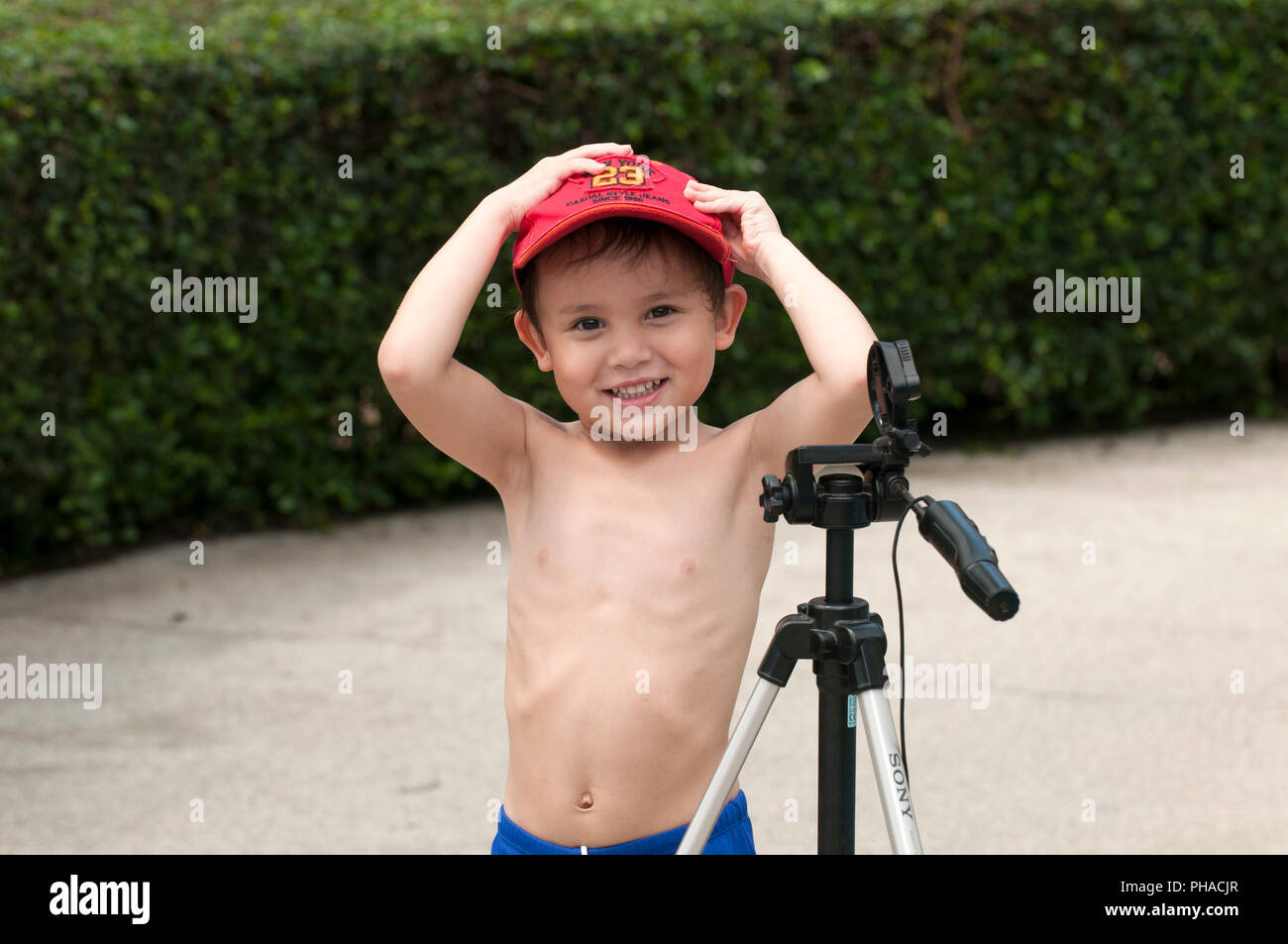 Child playing with photo tripod Stock Photo - Alamy