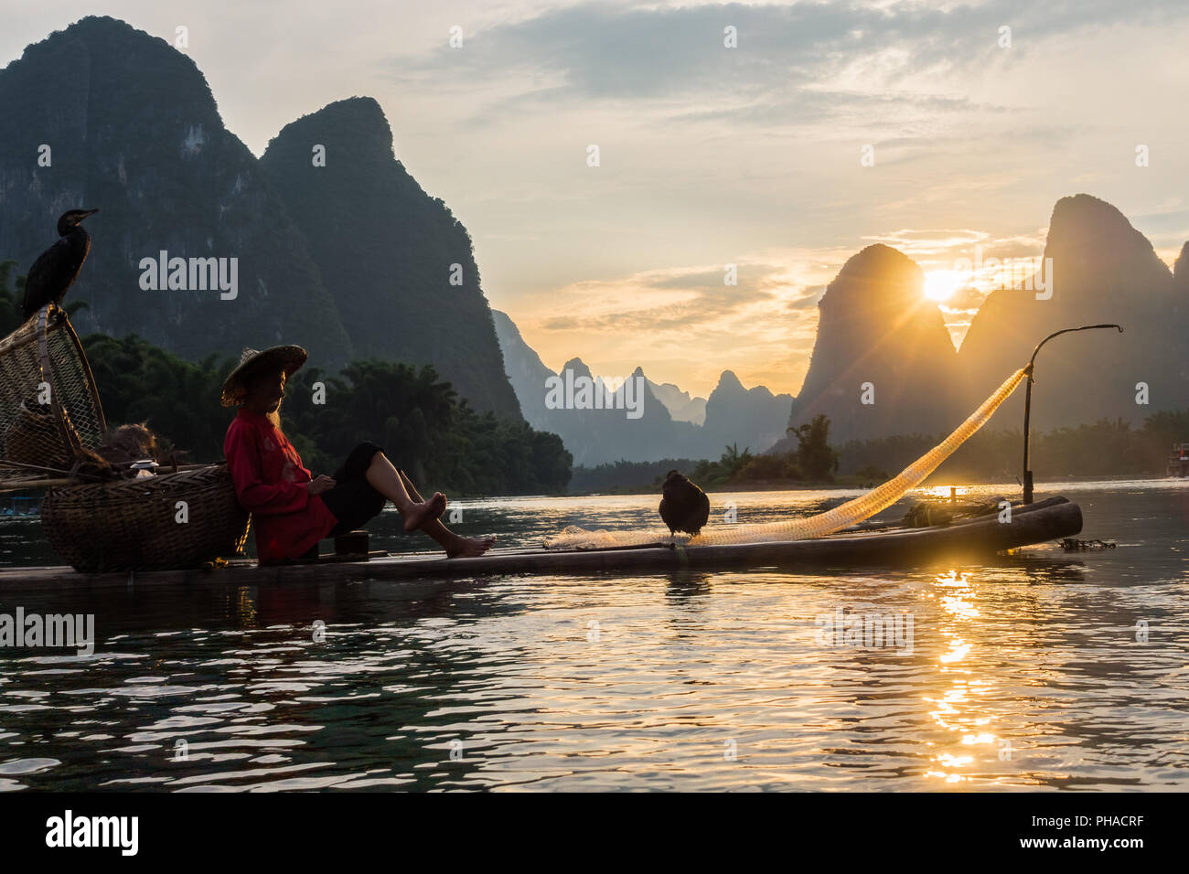 Yangshuo, China Sunset Landscape on Calm River with Villager on Boat ...