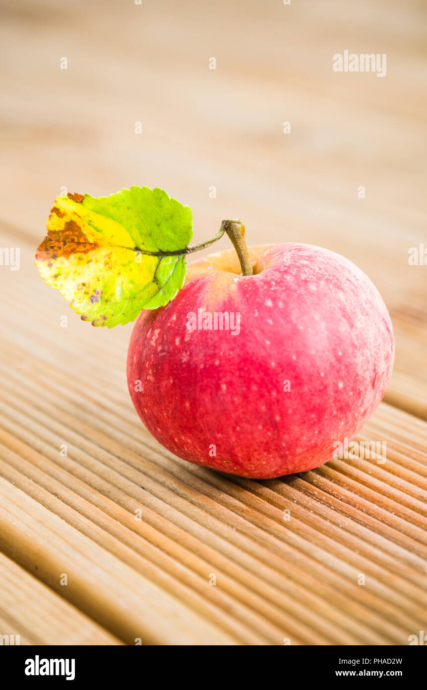 Ripe red apple with a leaf, close-up Stock Photo - Alamy