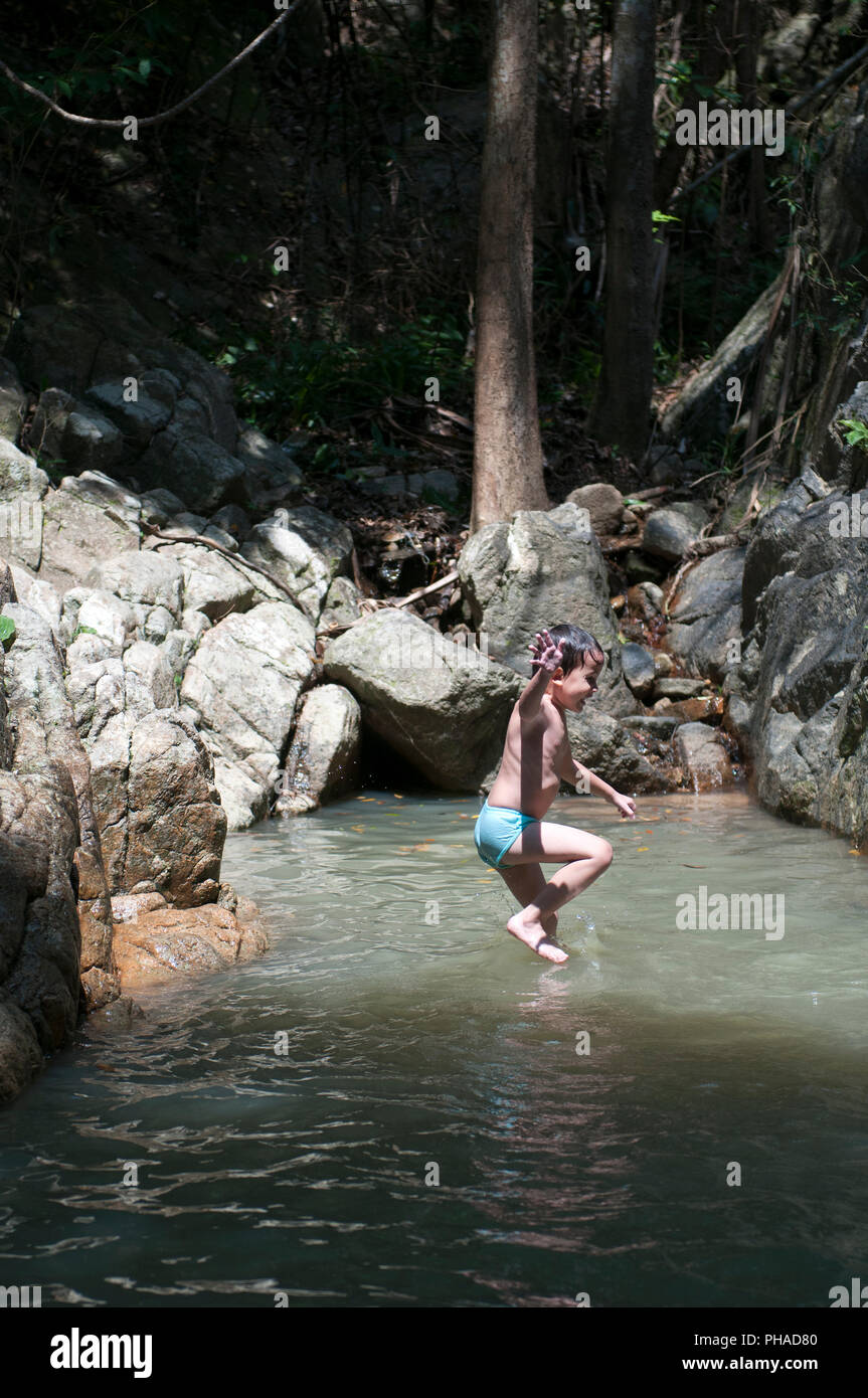 Child jumping in waterfall Stock Photo - Alamy