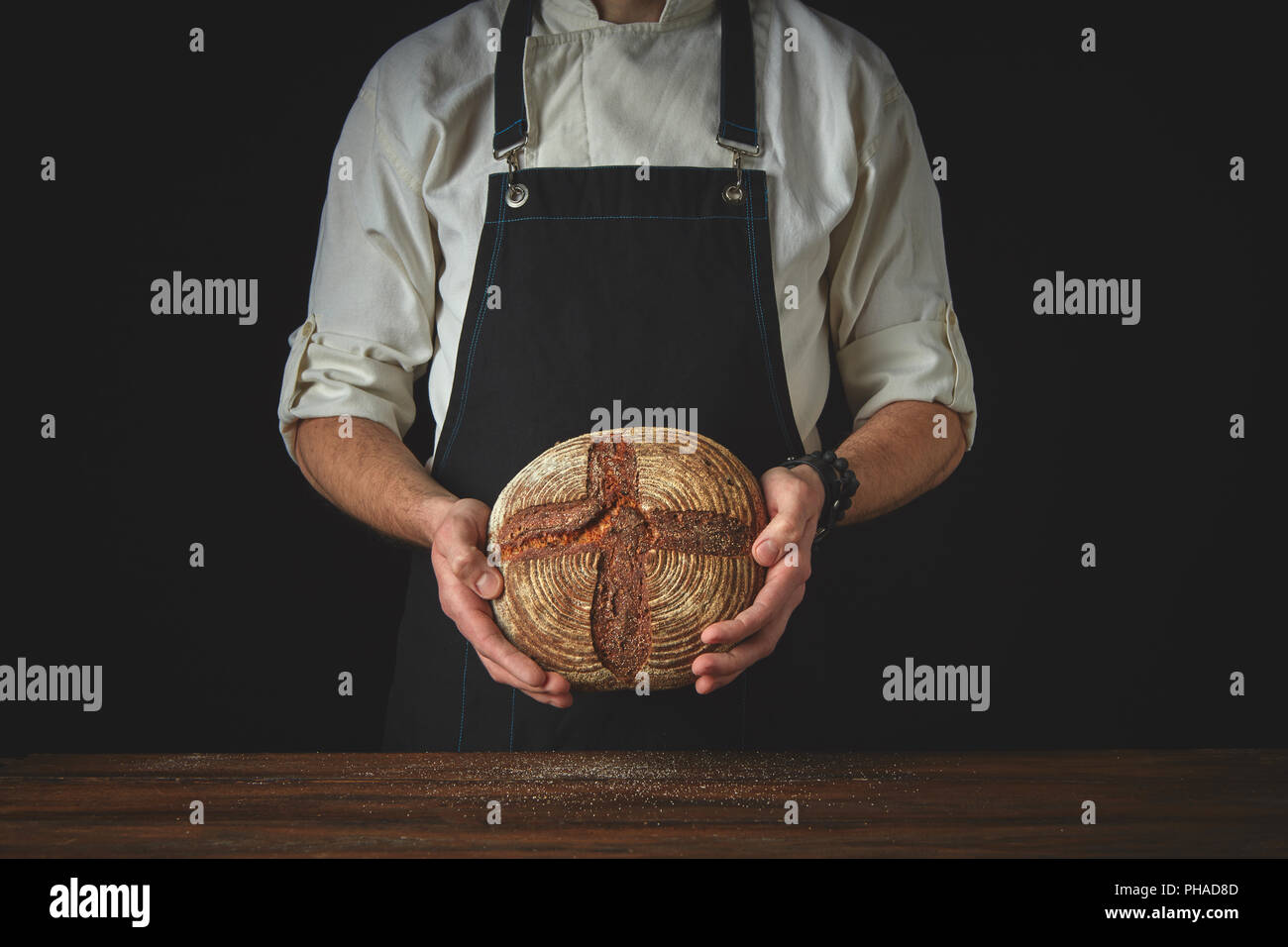 Men's hands hold bread Stock Photo - Alamy