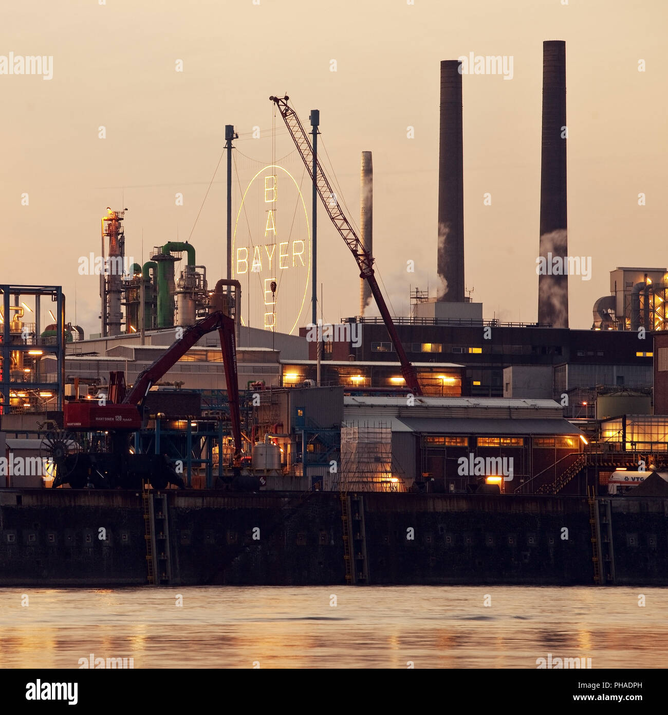 Bayer AG chemical plant on the Rhine riverbank in the early morning ...
