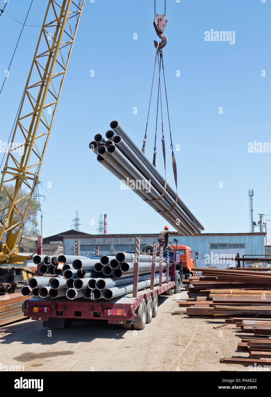 loading of steel products and tubes with crane Stock Photo - Alamy