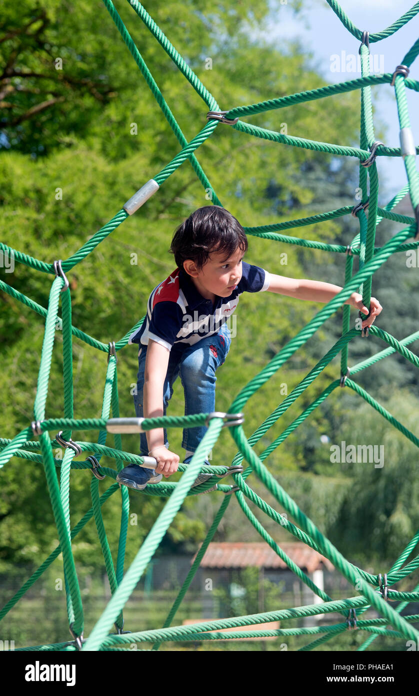 Child playing on a spiderweb, France Stock Photo - Alamy