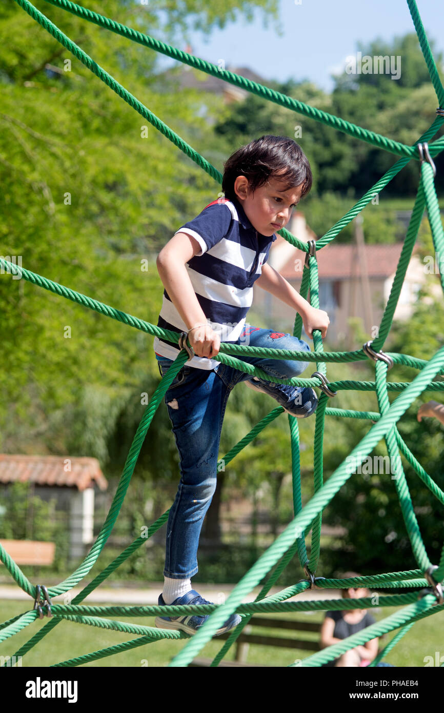 Child playing on a spiderweb, France Stock Photo - Alamy