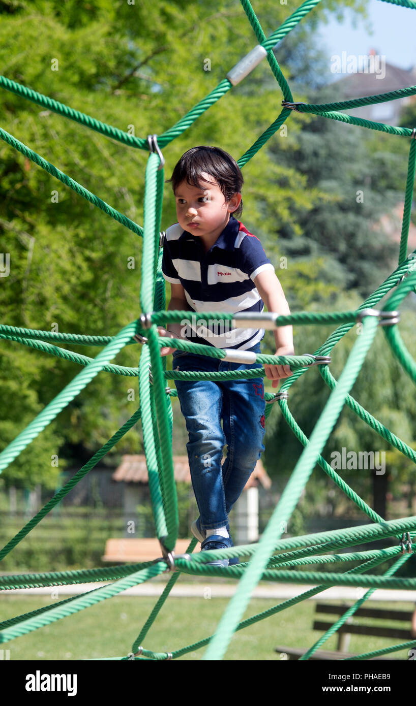 Child playing on a spiderweb, France Stock Photo - Alamy