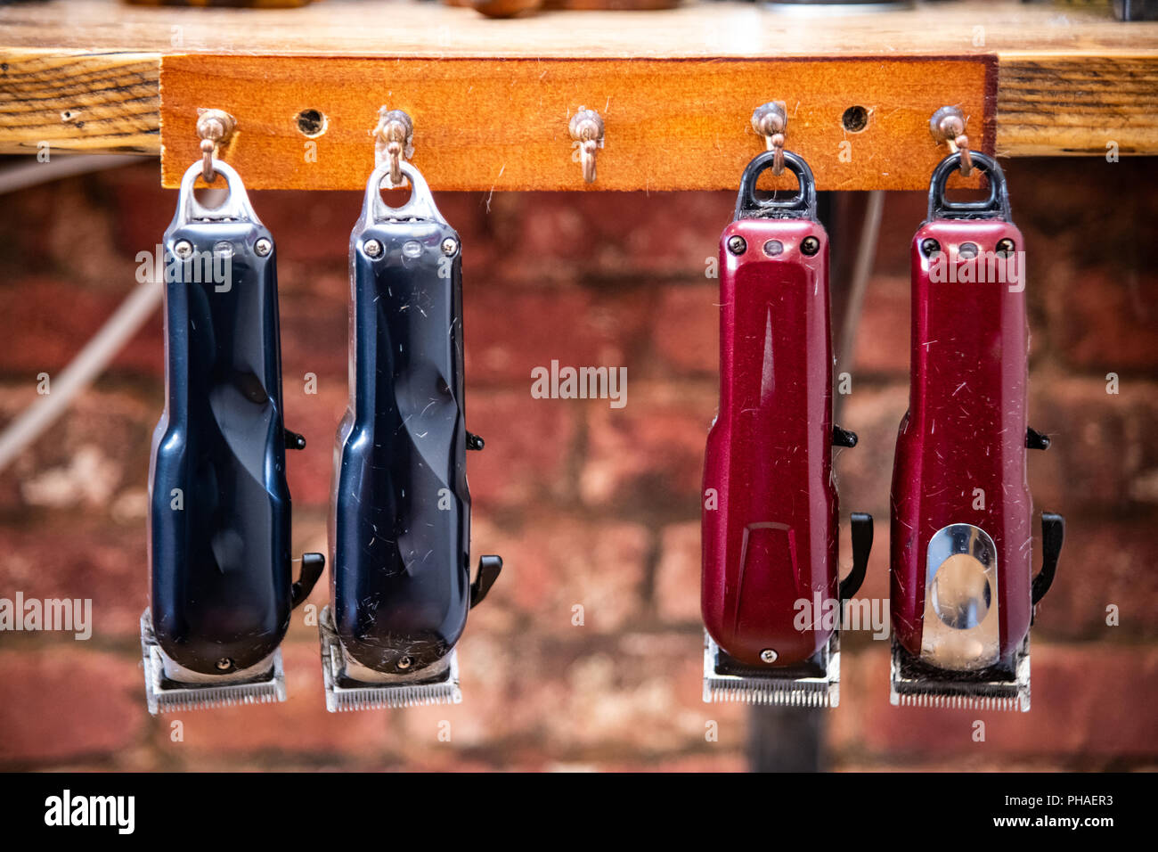 Modern Barber Hair Clippers / Shears hanging in salon Stock Photo - Alamy