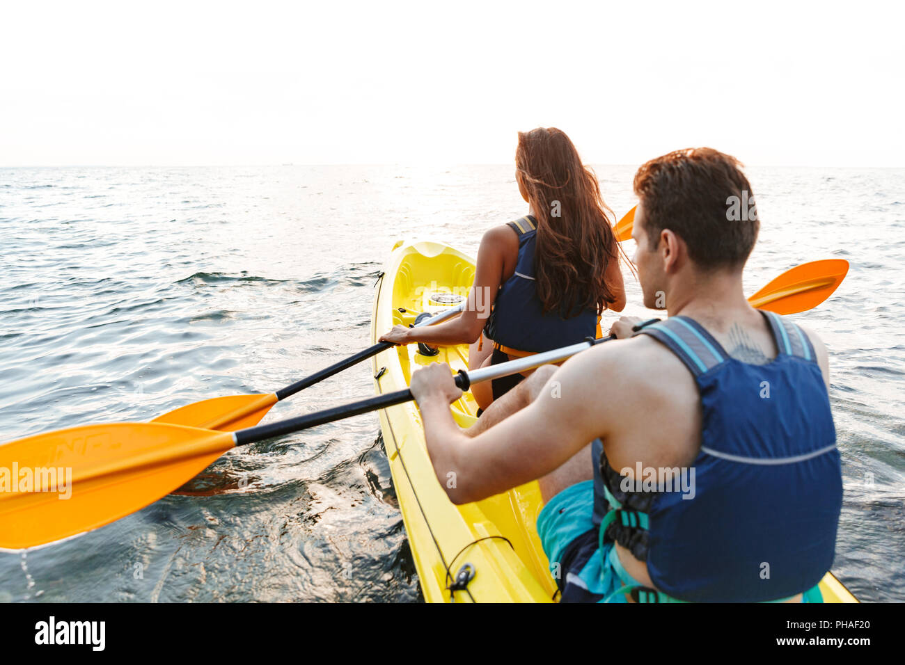 Back view of couple kayaking together Stock Photo - Alamy