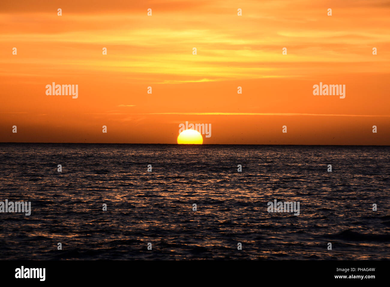 The Sun Setting in the Sea Stock Photo - Alamy