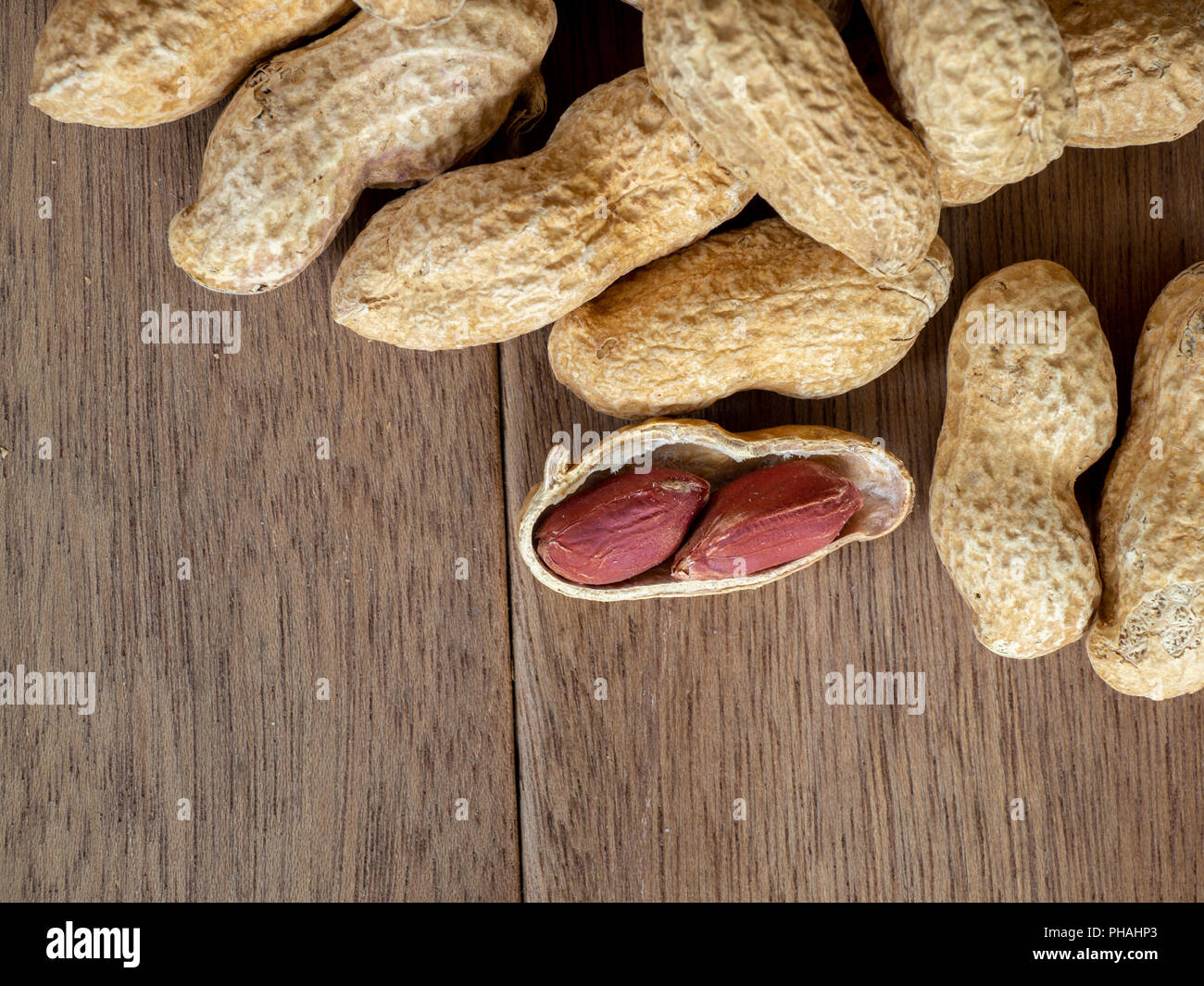 Dried peanuts in shells on peanuts background on wooden table. Concept ...