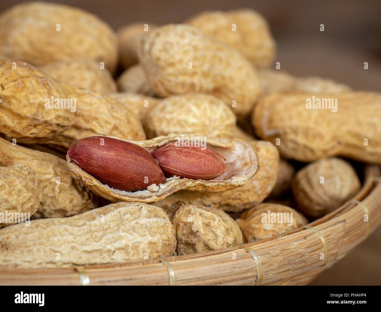 Dried peanuts in shells on peanuts background on wooden table. Concept ...