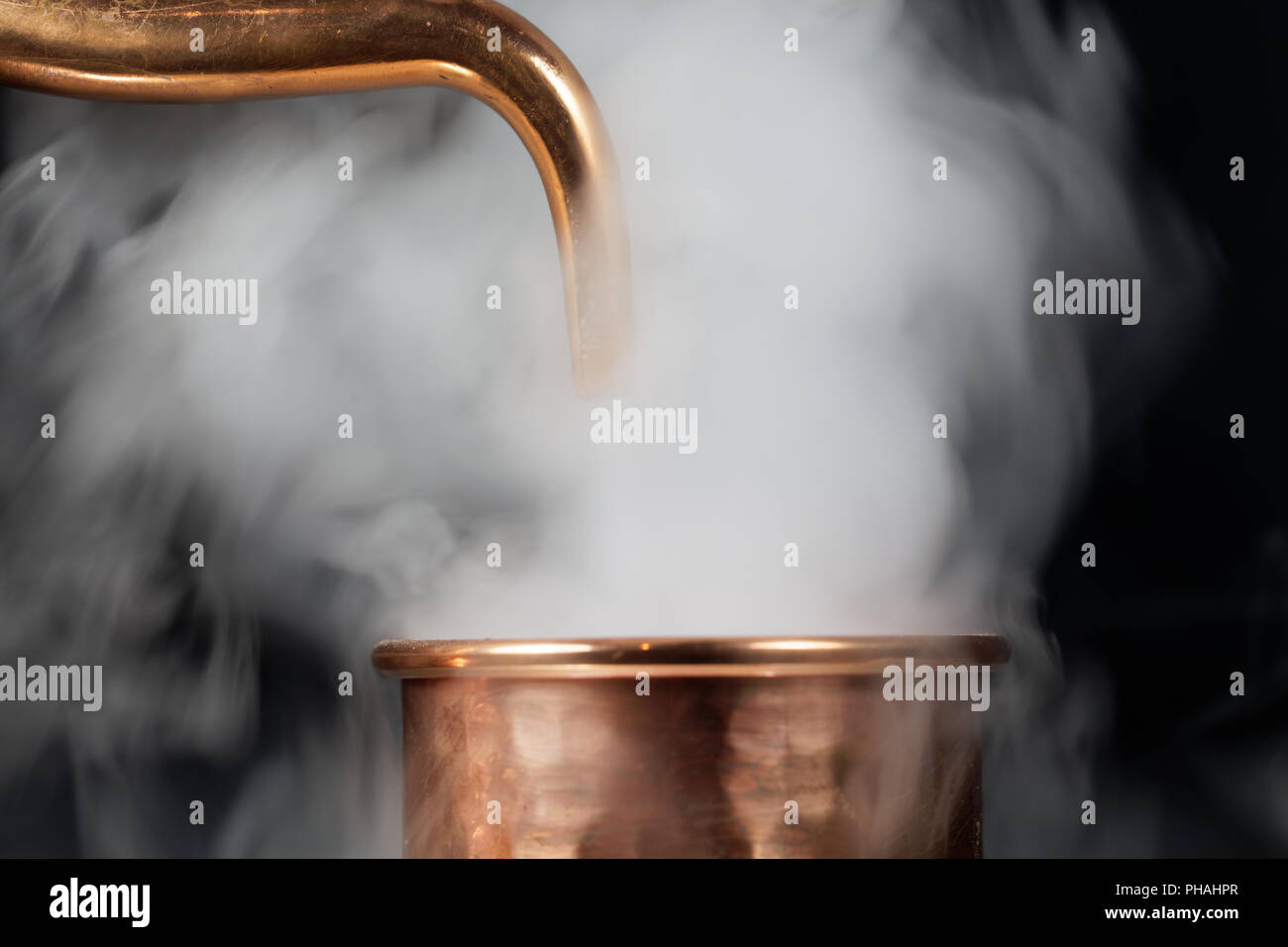A copper pipe of a distillery with steam Stock Photo - Alamy