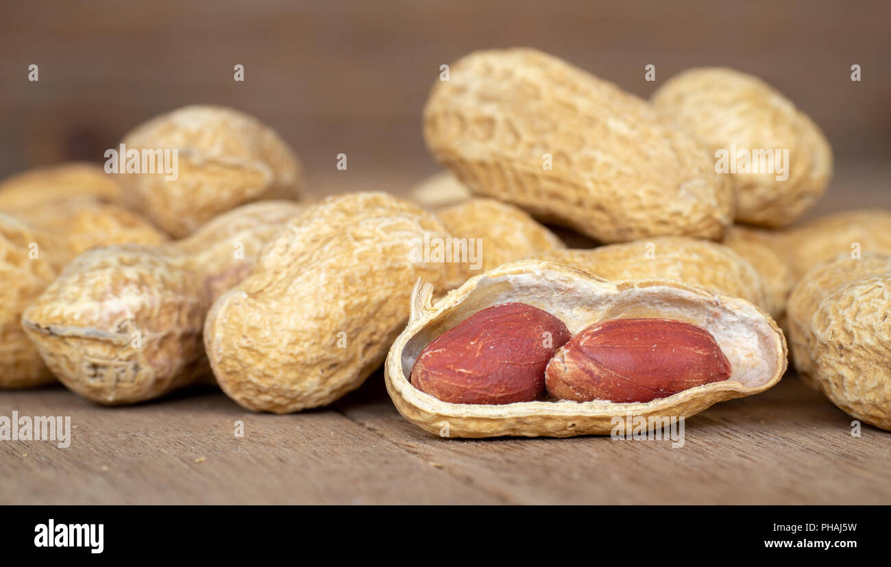 Dried peanuts in shells on peanuts background on wooden table. Concept ...