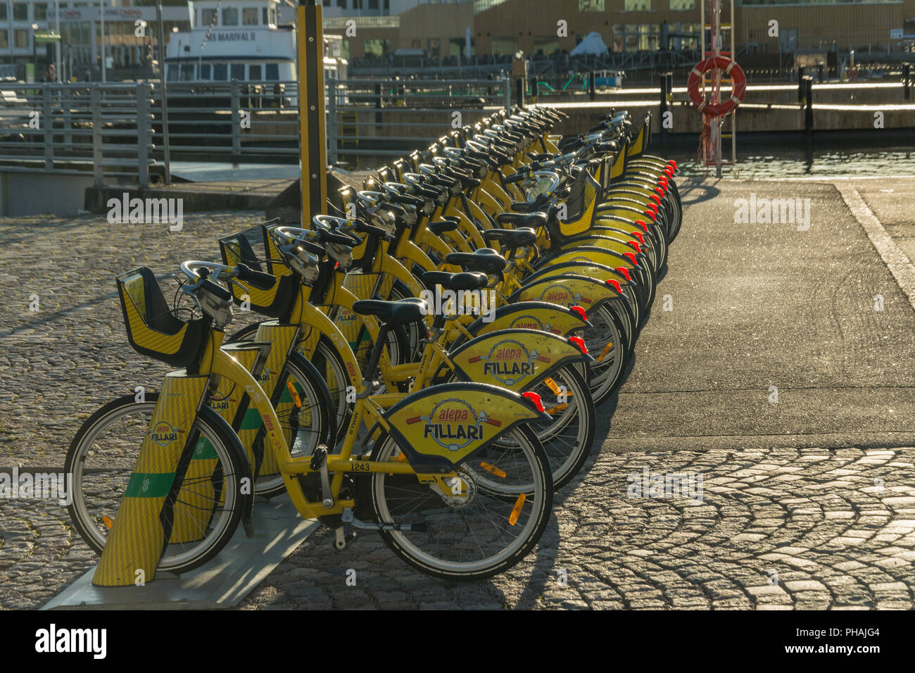 Yellow rental bicycles at Helsinki Market square Stock Photo - Alamy