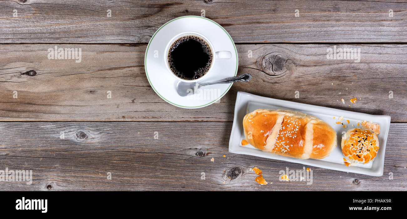 Morning pastry meal and dark coffee on rustic table Stock Photo - Alamy