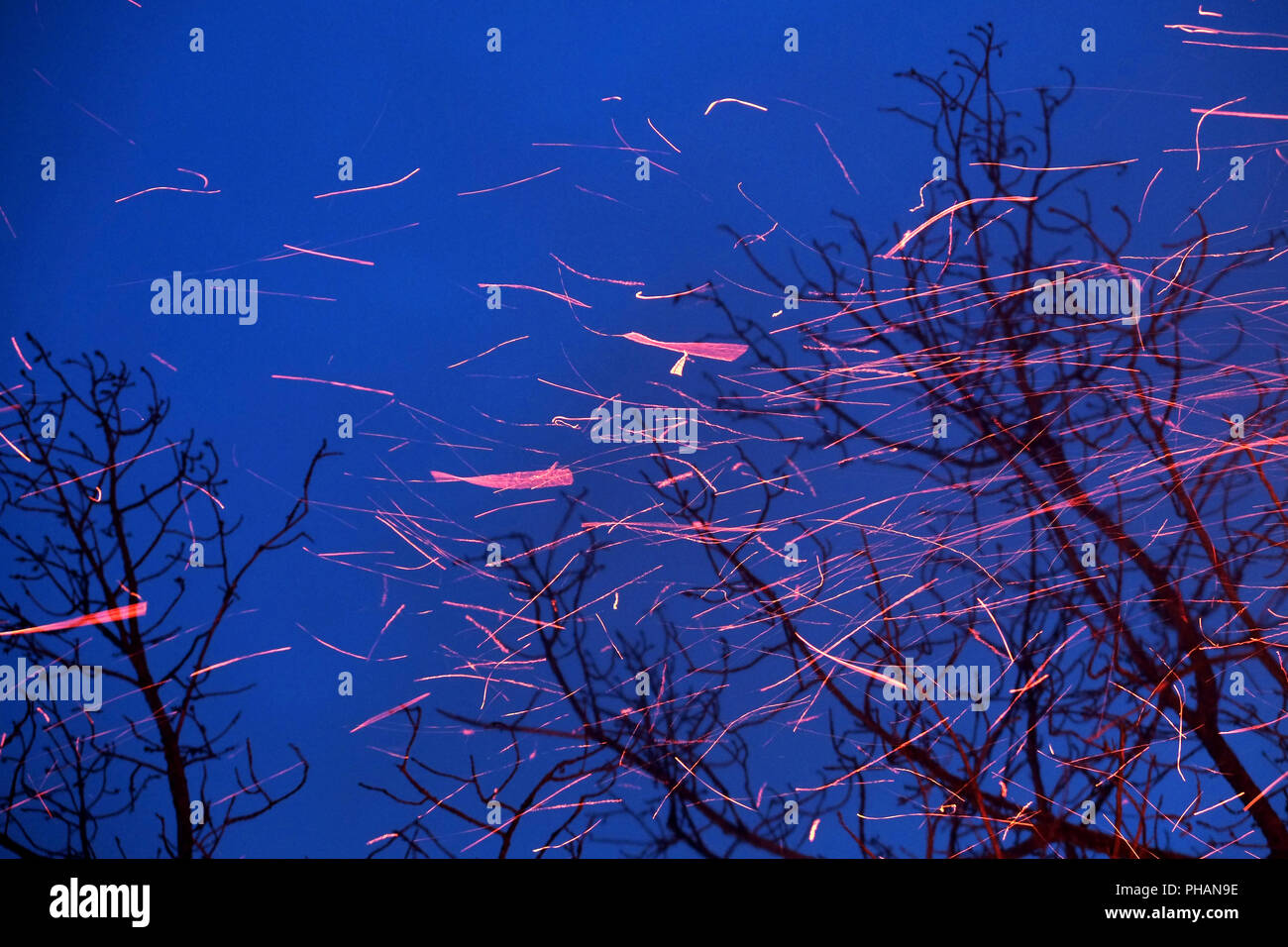 Flying sparks on the night sky Stock Photo - Alamy