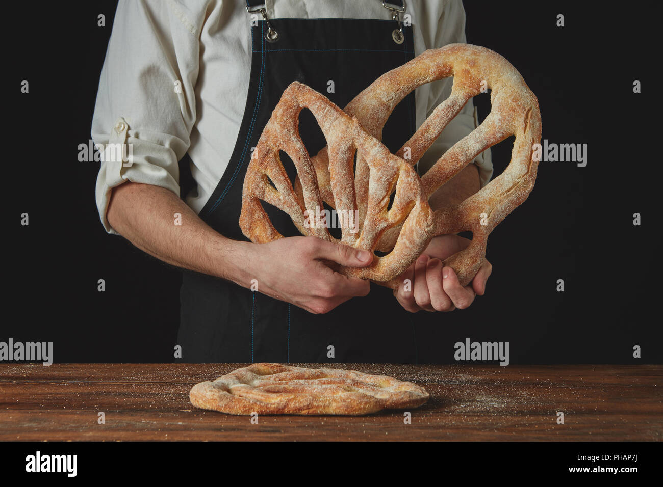 baker is holding fougas bread Stock Photo - Alamy
