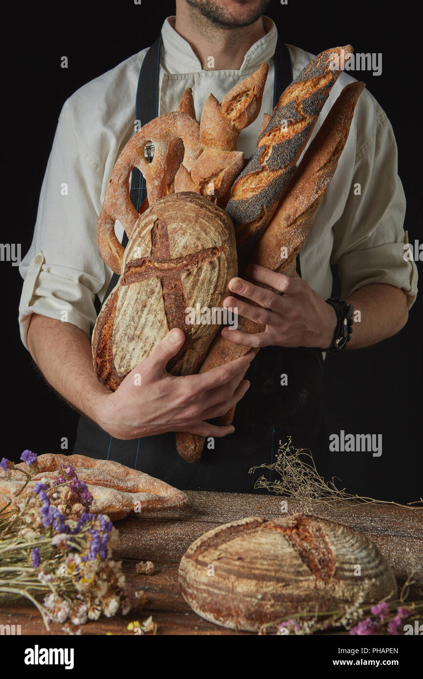 Variety of bread hold men's hands Stock Photo - Alamy