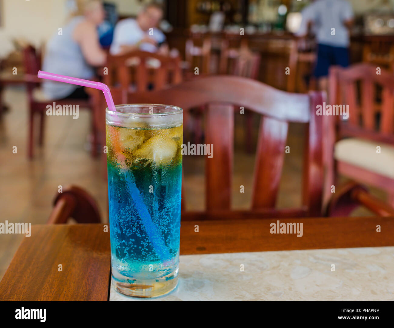 Frosty yellow and blue alcoholic beverage, with condensation on the ...