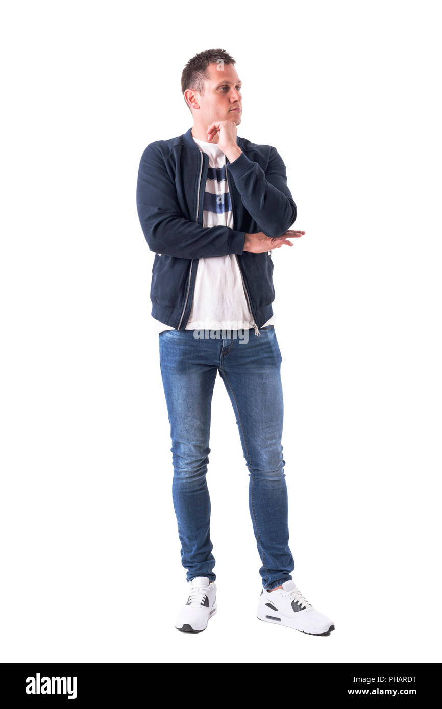 One young adult casual man looking away thoughtful and concerned at ...