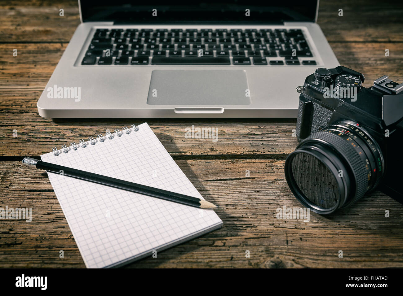 Office workstation with laptop, camera and notebook Stock Photo - Alamy