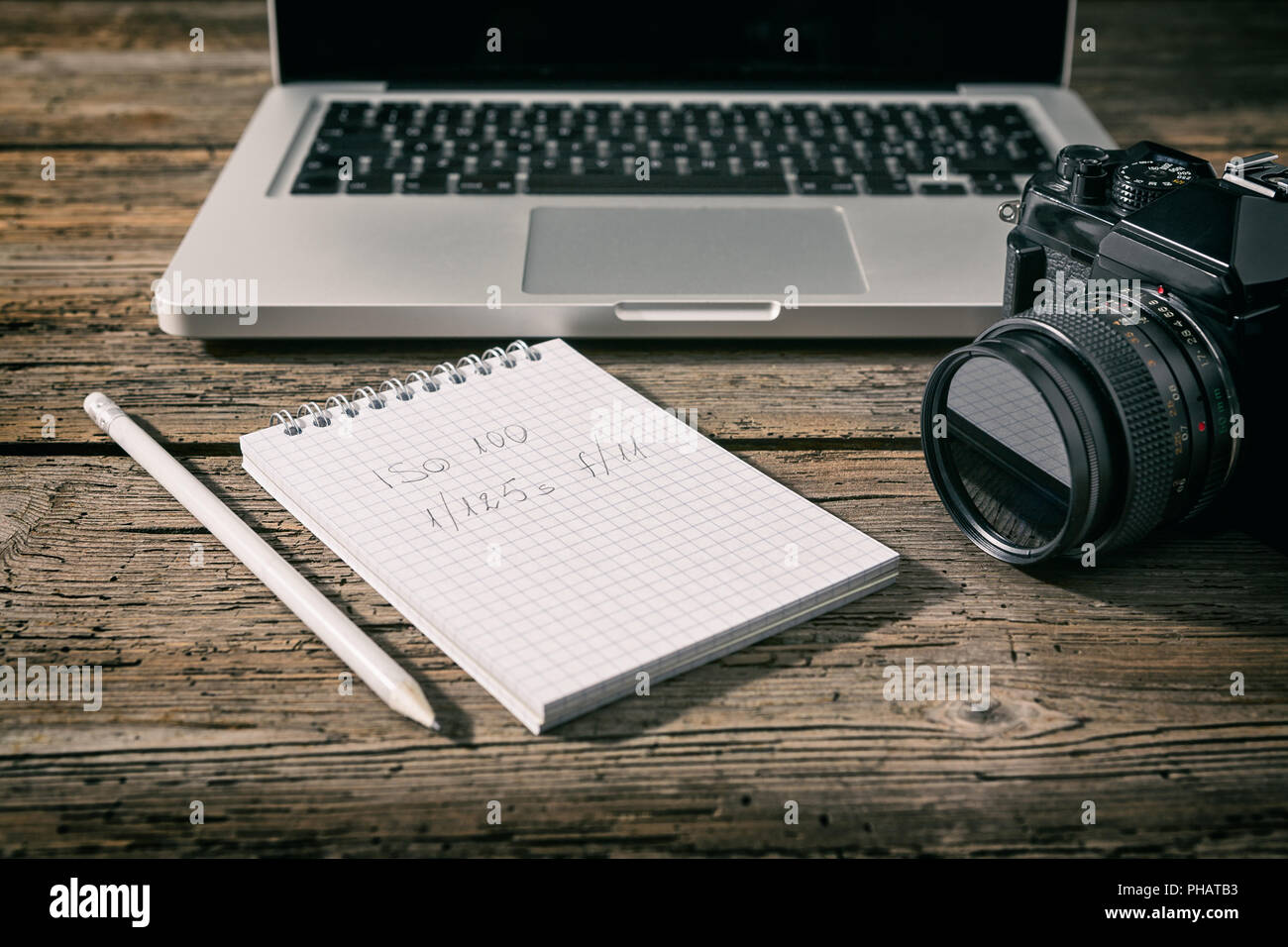Office workstation with laptop, notebook and camera Stock Photo - Alamy