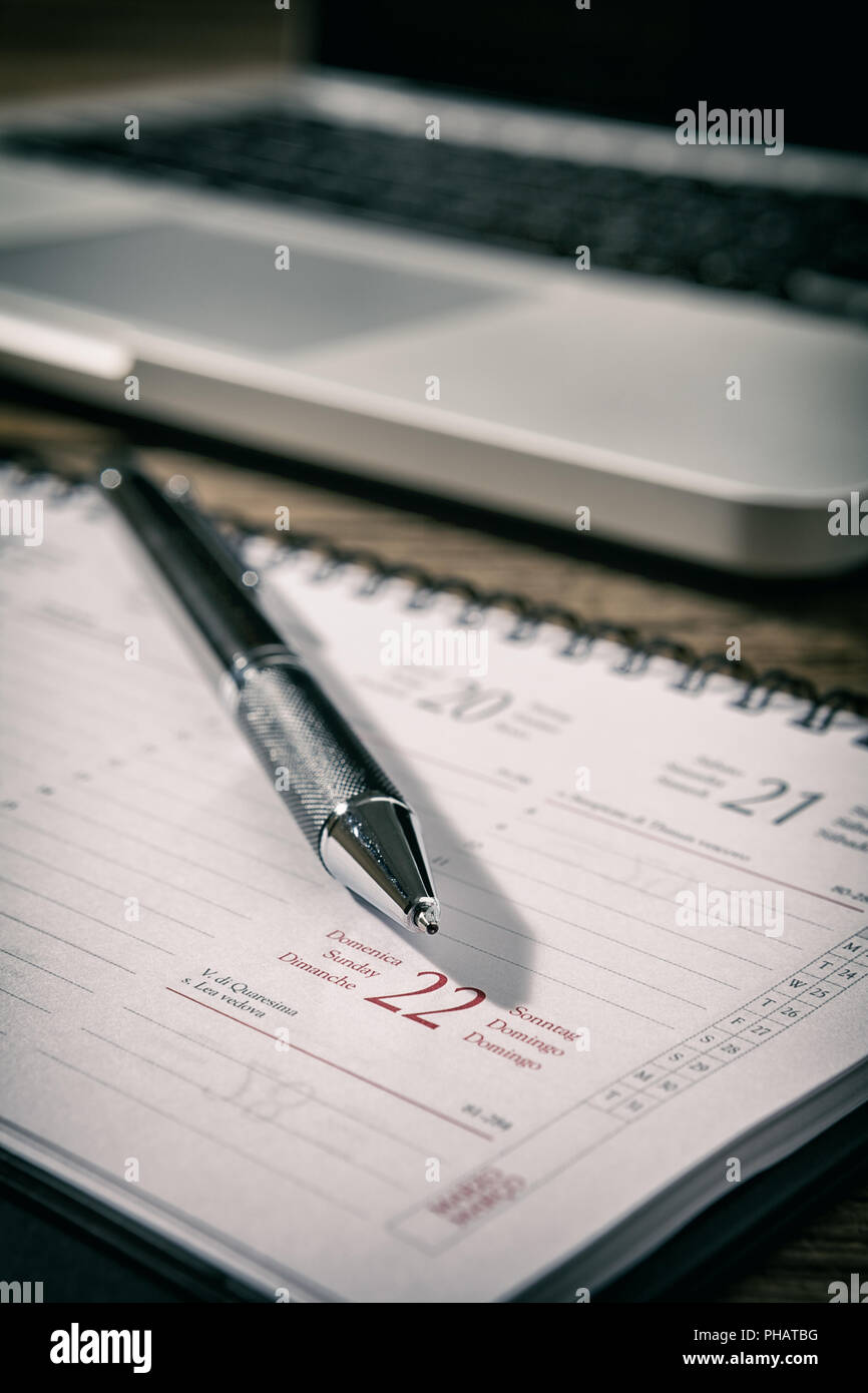 Closeup of a pen over a planner Stock Photo - Alamy