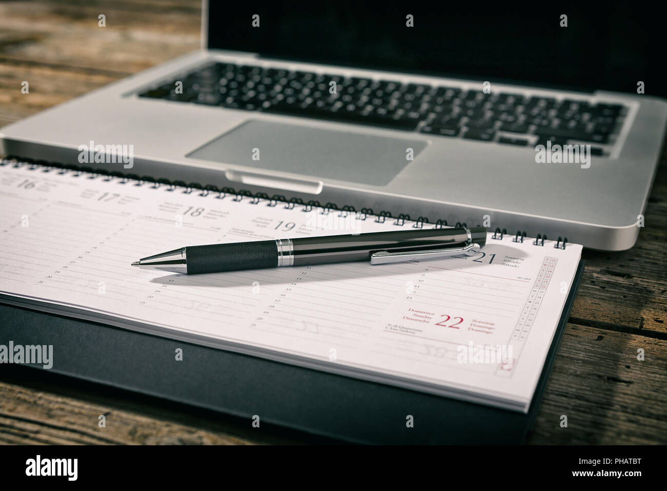 Office workstation with laptop, agenda and pen Stock Photo - Alamy