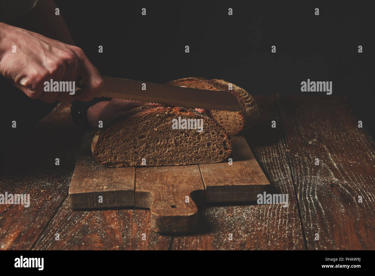Hands cutting bread hi-res stock photography and images - Alamy