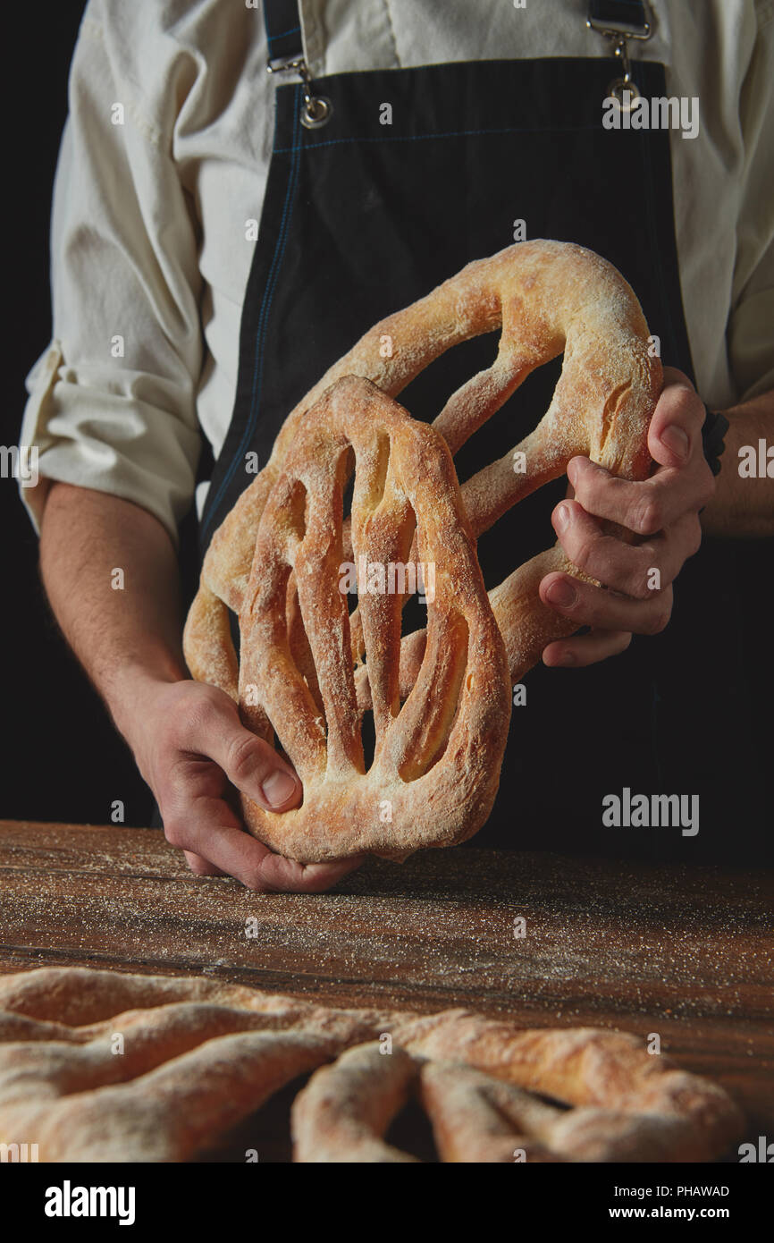 Baker is holding fougas bread Stock Photo - Alamy