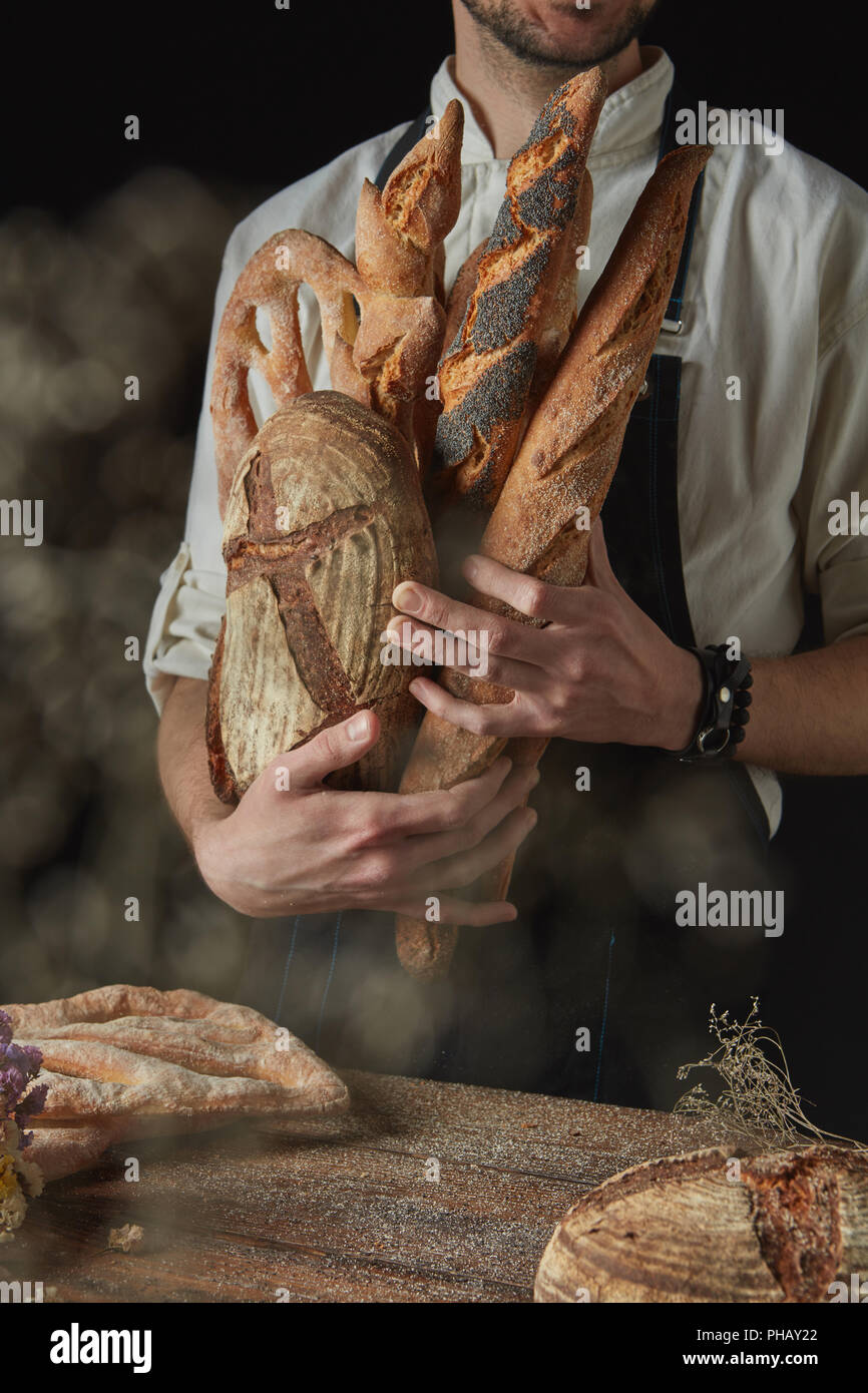 Variety of bread hold men's hands Stock Photo - Alamy