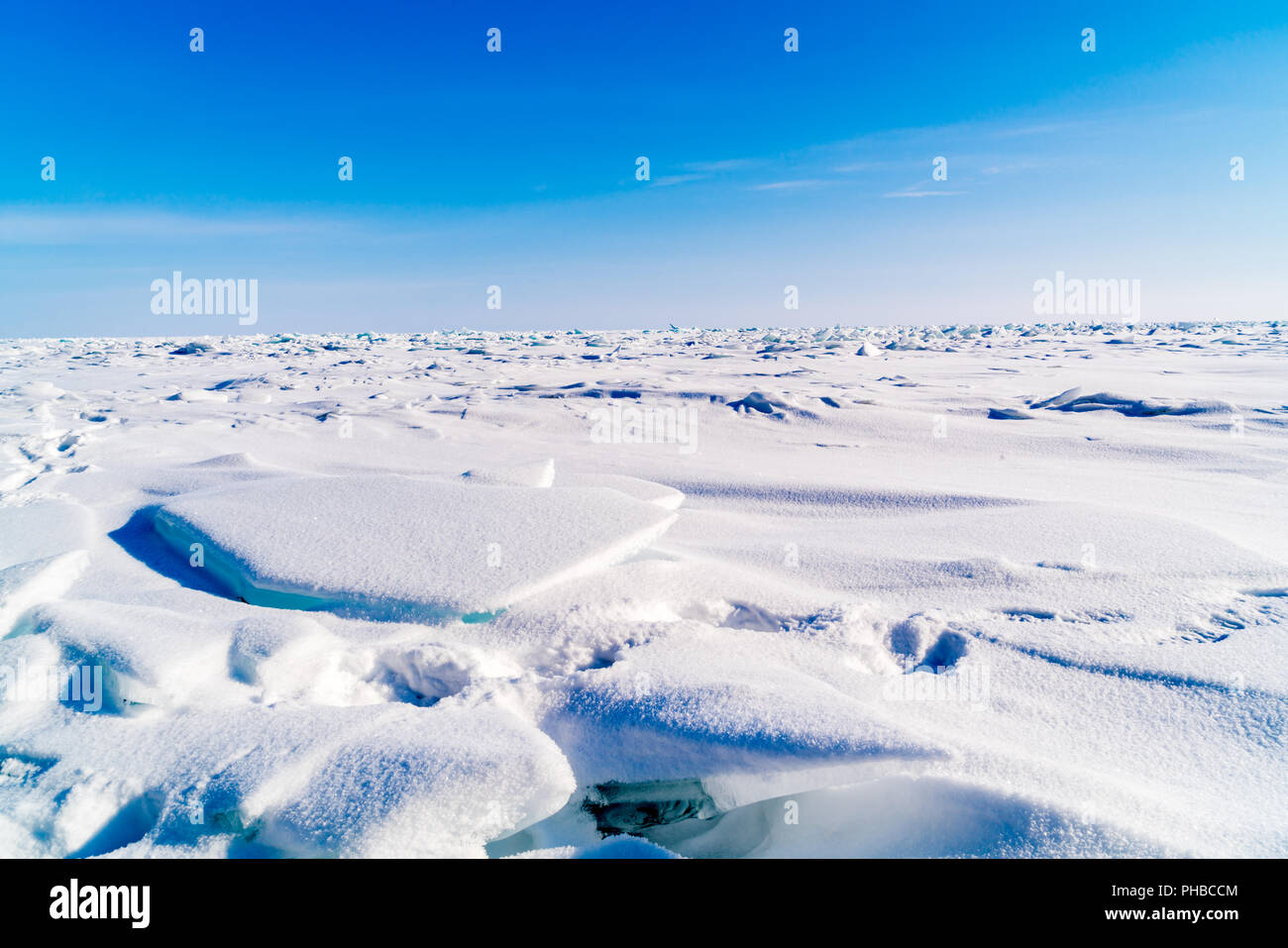 Field of blue frozen water covered with snow Stock Photo - Alamy