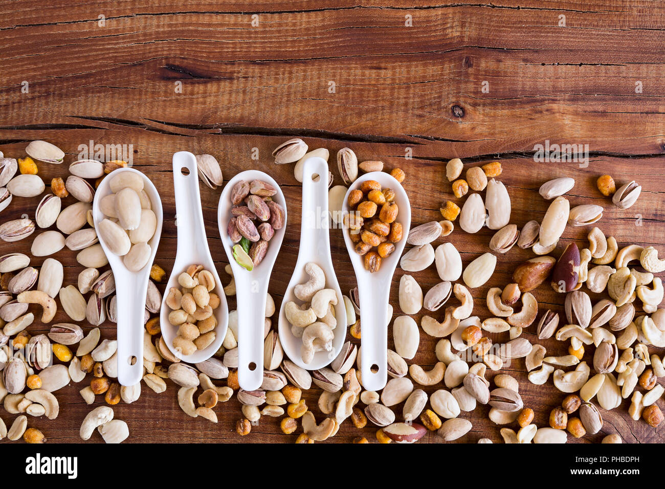 Mix of nuts over a rustic table Stock Photo - Alamy