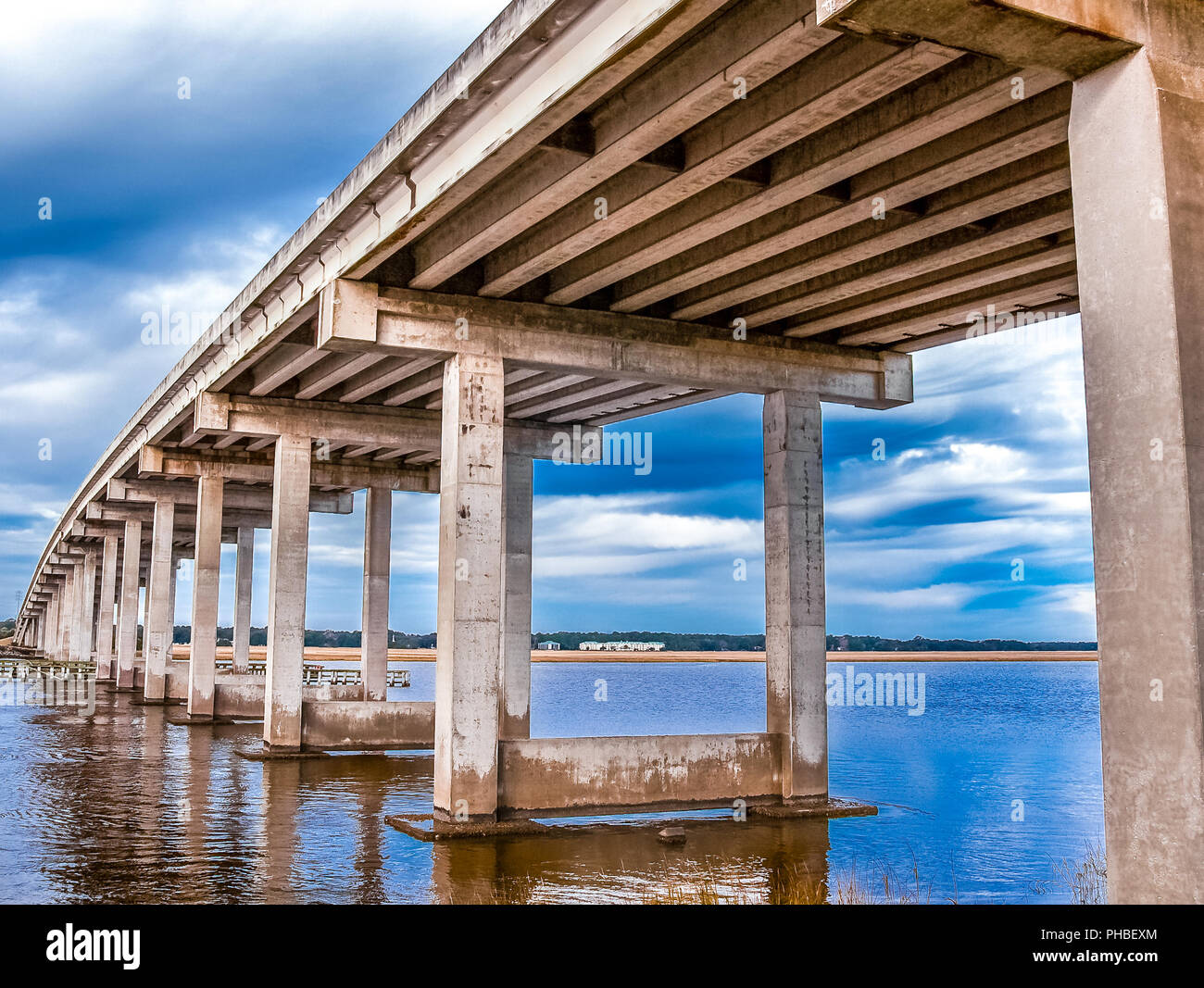 A concrete bridge spanning shallow water by old road Stock Photo - Alamy