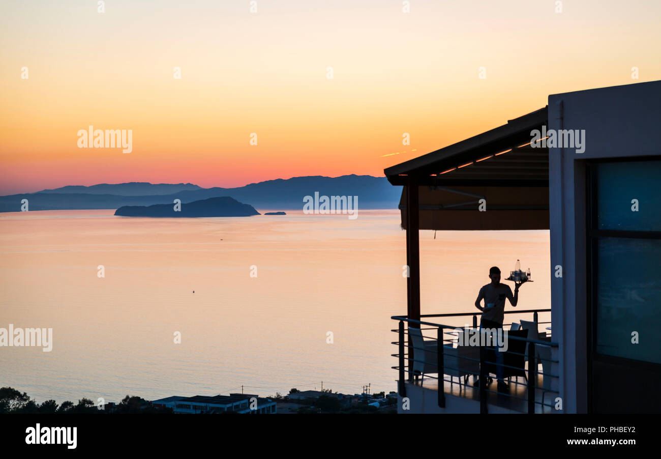 Gloomy sunset and waiter, Akrotiri, Crete, Greek Islands, Greece ...