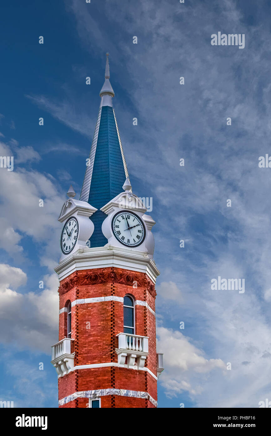 An old fashioned brick clock tower rising into a cloudy sky Stock Photo ...