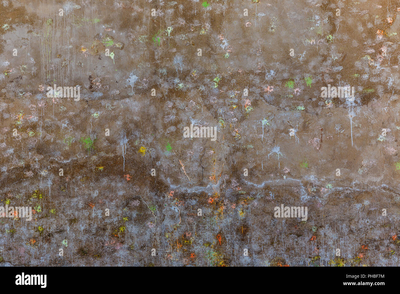 Concrete wall covered with stains of paint from shots into the game ...