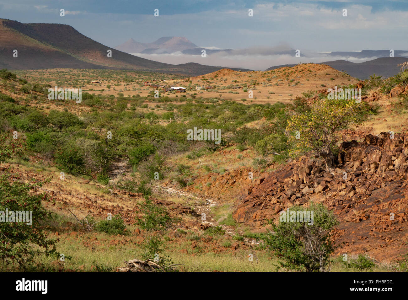 Colourful rocky landscape high up in the hills, with mountain camp in ...
