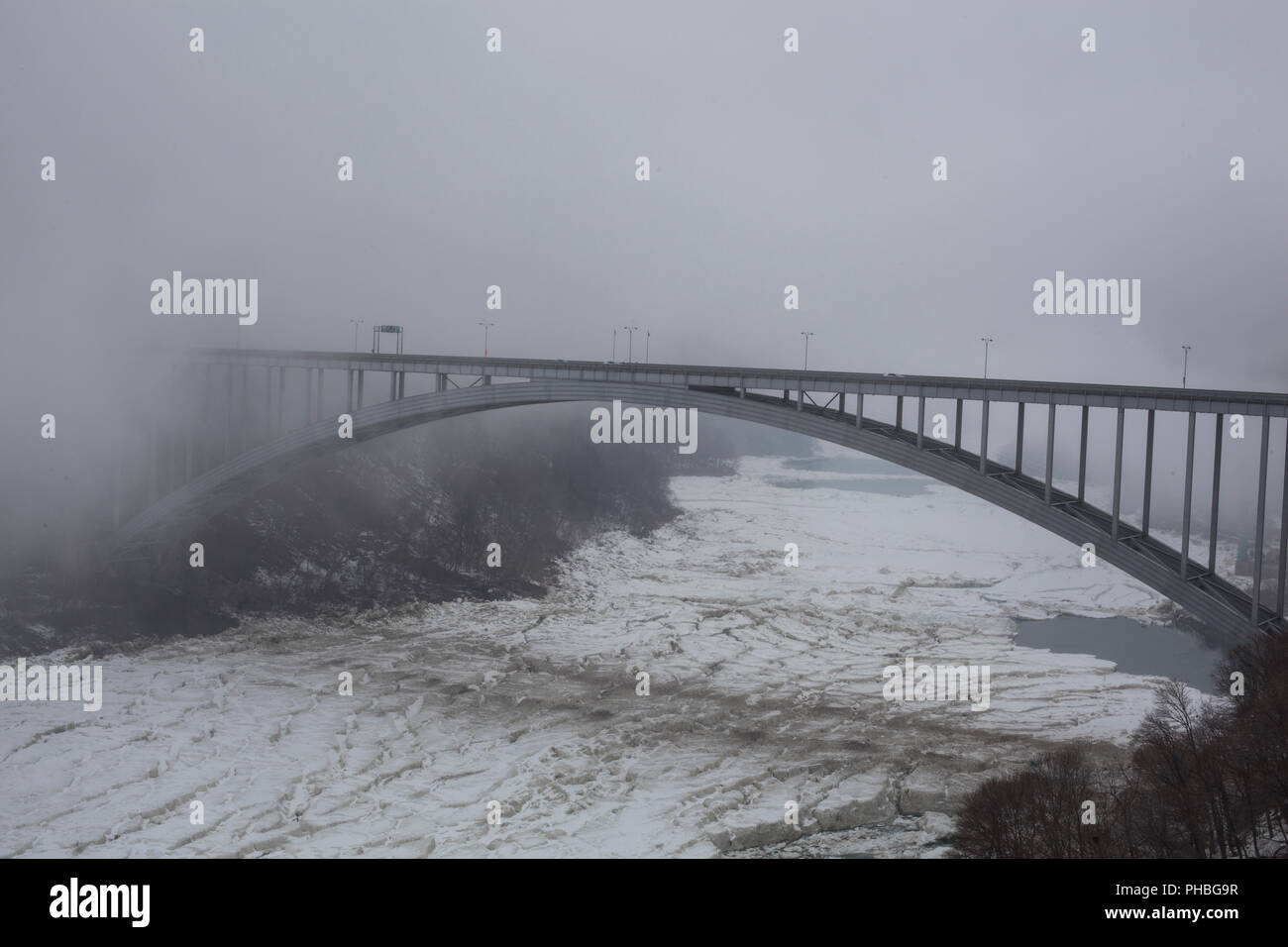 Niagara falls International Rainbow bridge in the winter with foggy ...