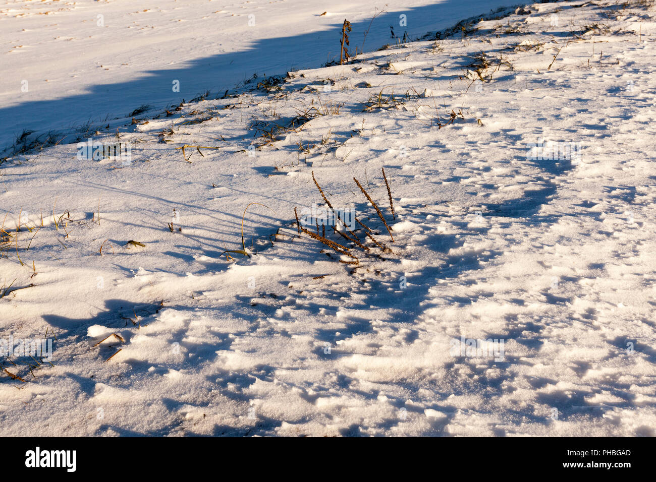 snow lying in snowdrifts after the last snowfall, winter with little ...
