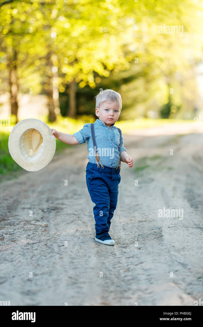 Toddler child outdoors. Rural scene with one year old baby boy with ...