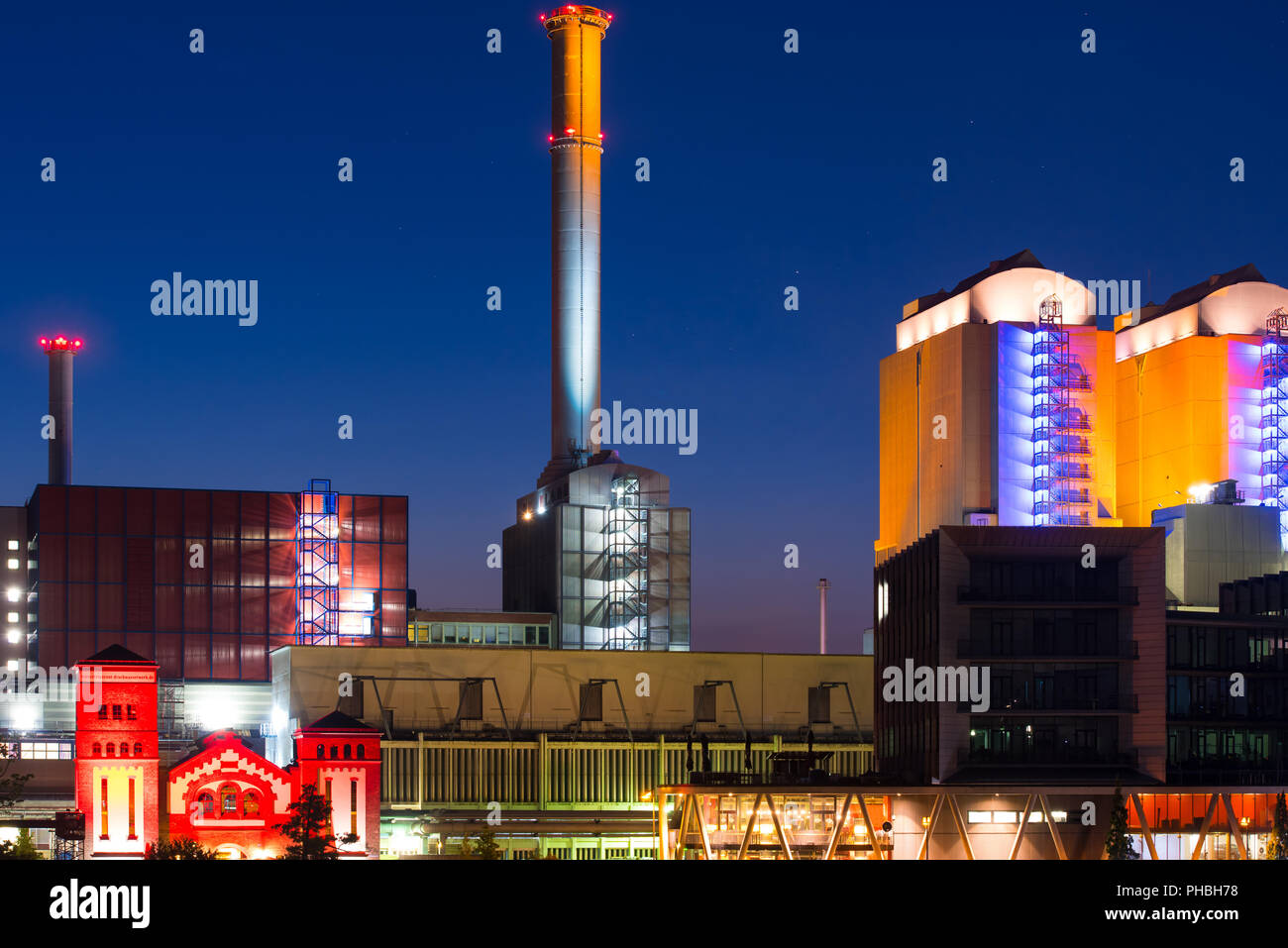 Illuminated factory in twilight Stock Photo - Alamy
