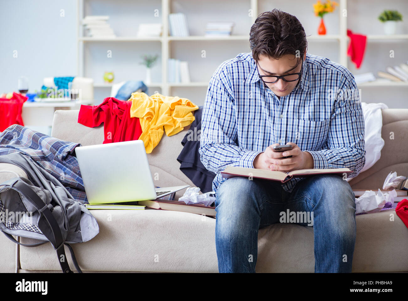 Young man working studying in messy room Stock Photo - Alamy