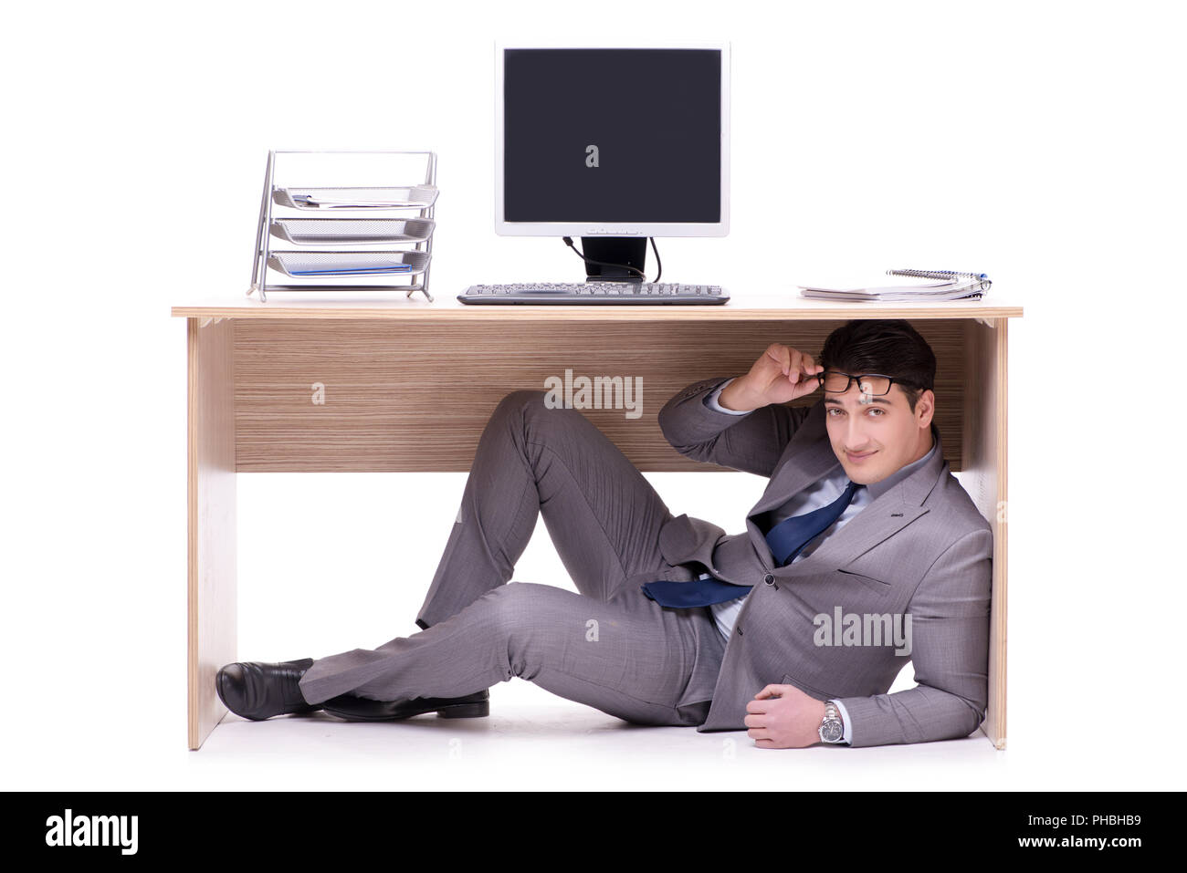 Person hiding under desk Cut Out Stock Images & Pictures - Alamy