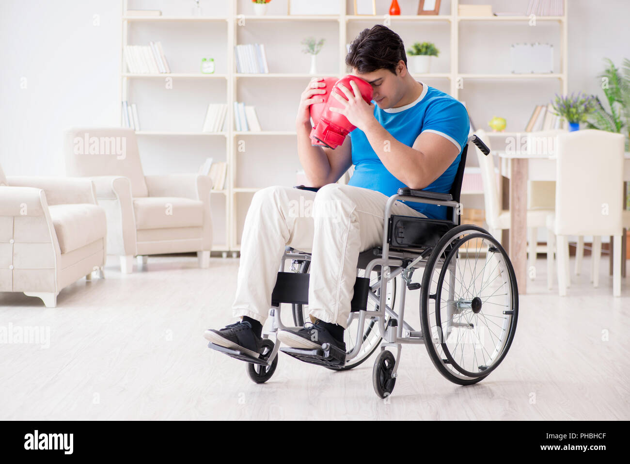 Disabled boxer at wheelchair recovering from injury Stock Photo - Alamy