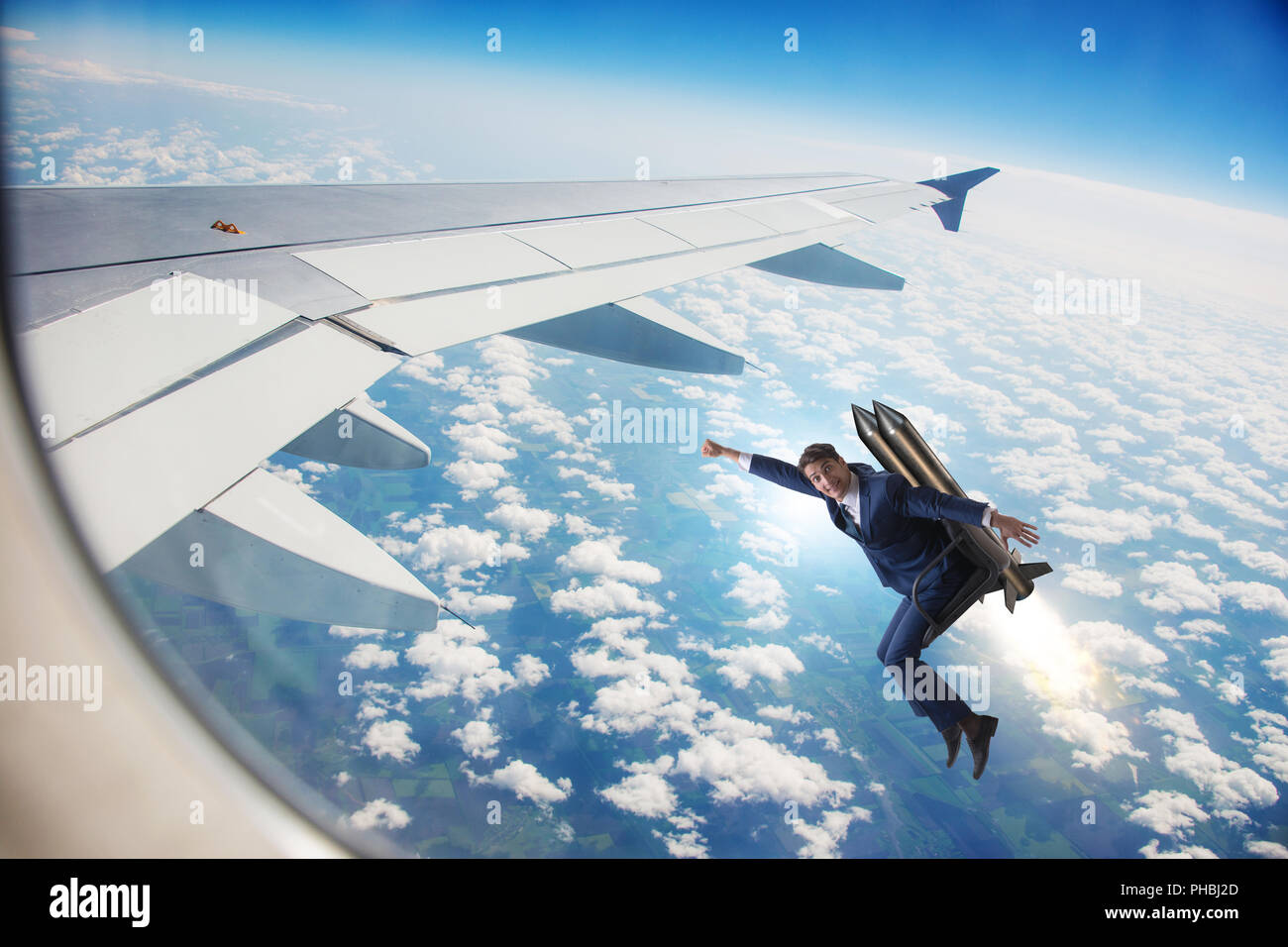 Businessman flying next to commercial flight Stock Photo - Alamy