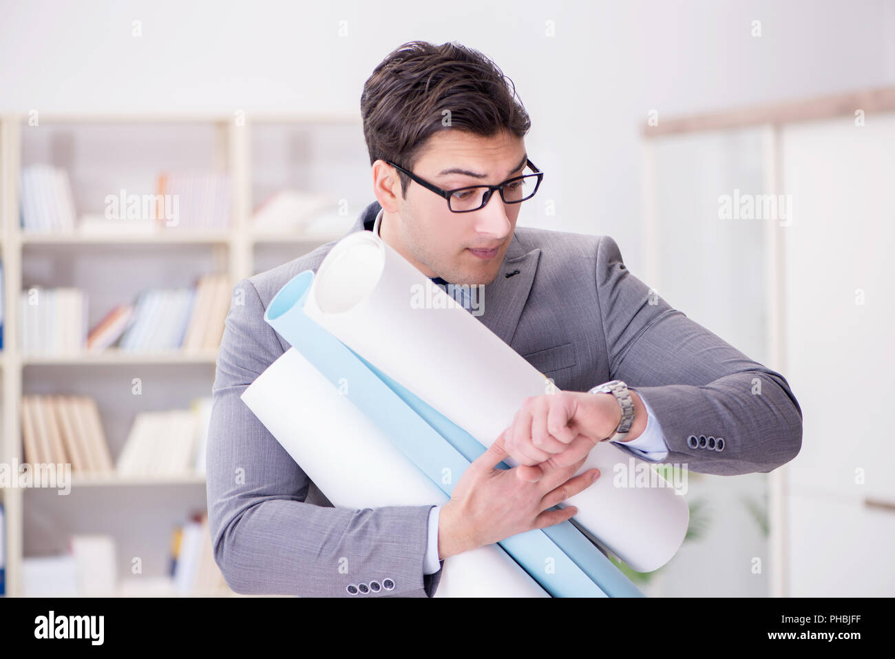Businessman engineer draftsman with blueprints drawings Stock Photo - Alamy